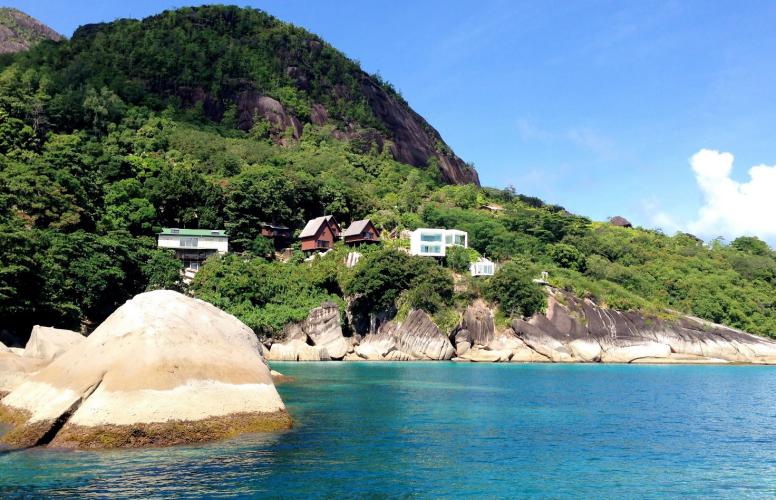 View of Gotham House from the sea with mountain backdrop